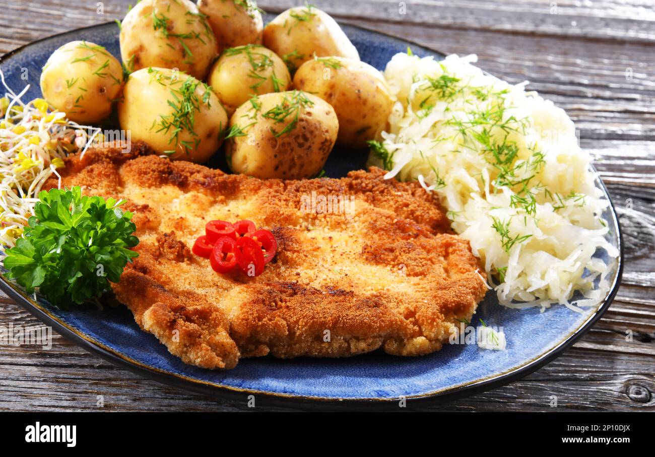Pork breaded cutlet coated with breadcrumbs served with potatoes and ...