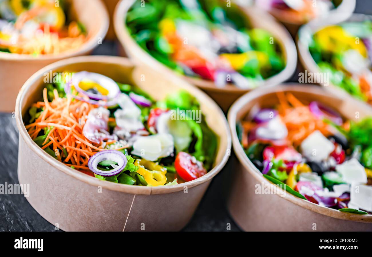 Round paper boxes with pre-packaged vegetable salads ready for sale ...