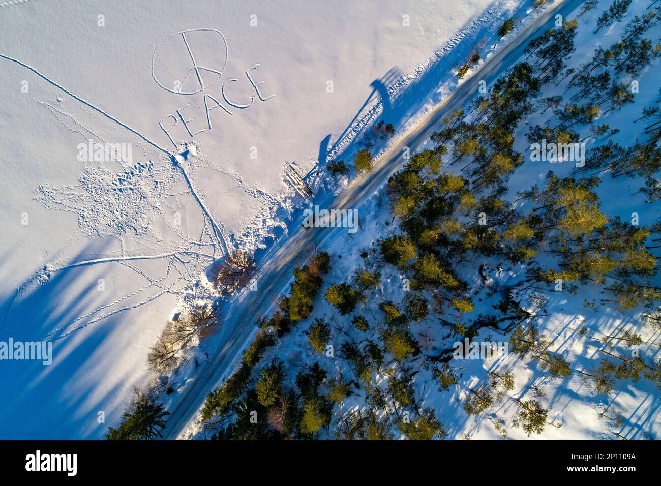 A scenic winter landscape featuring a winding road through a snow ...