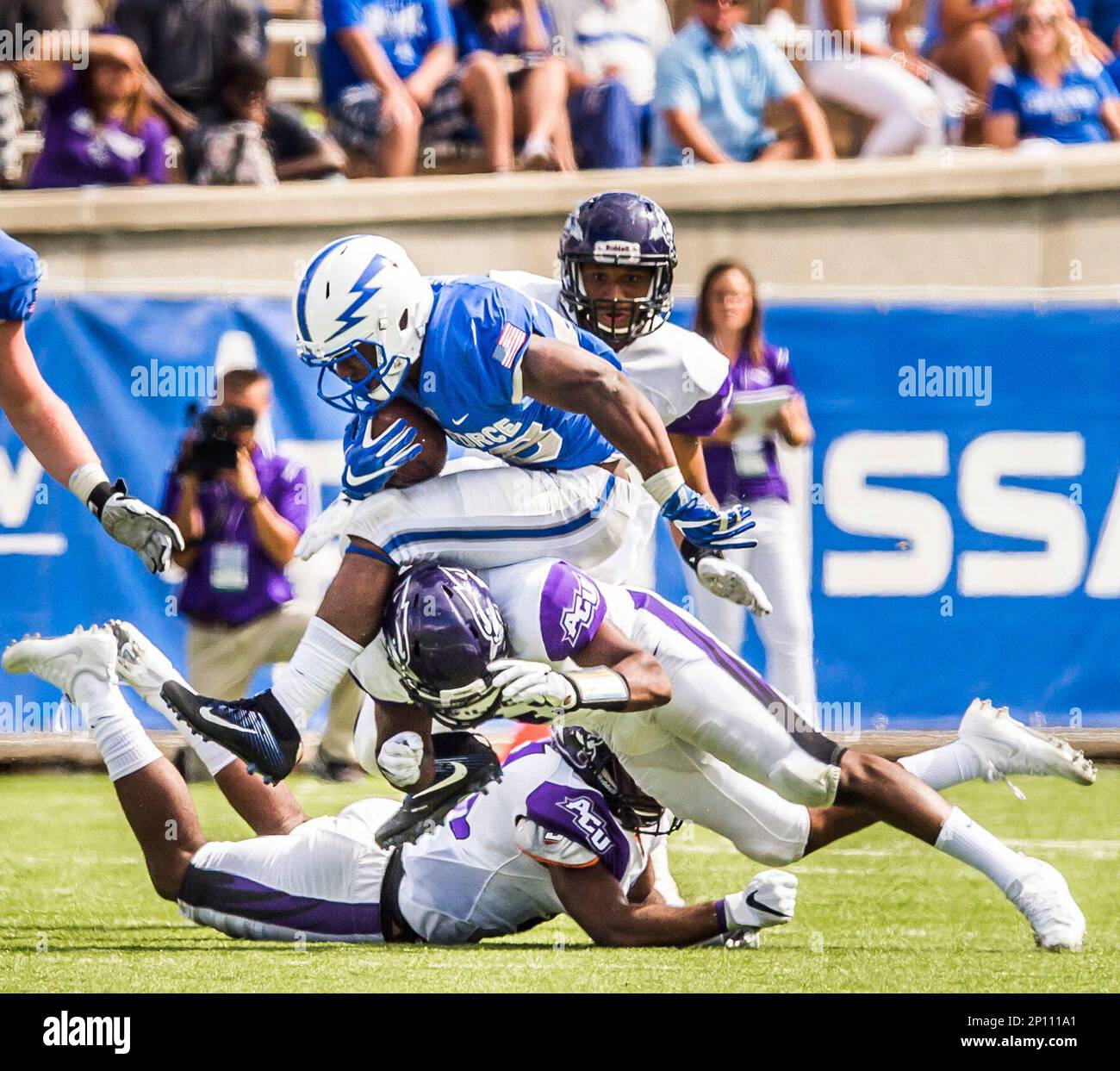Air Force running back Jacobi Owens, top, gets tackled by Abilene ...