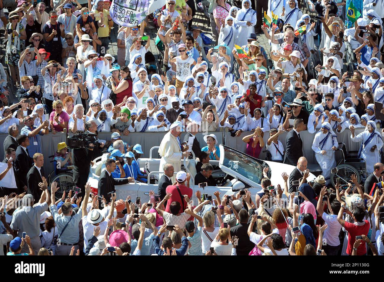 Pope Francis is driven through the crowd in St. Peter's Square at the ...