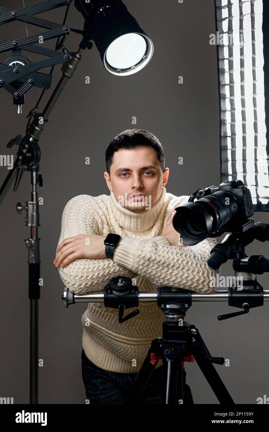 Professional handsome photographer with digital camera on tripod Stock ...