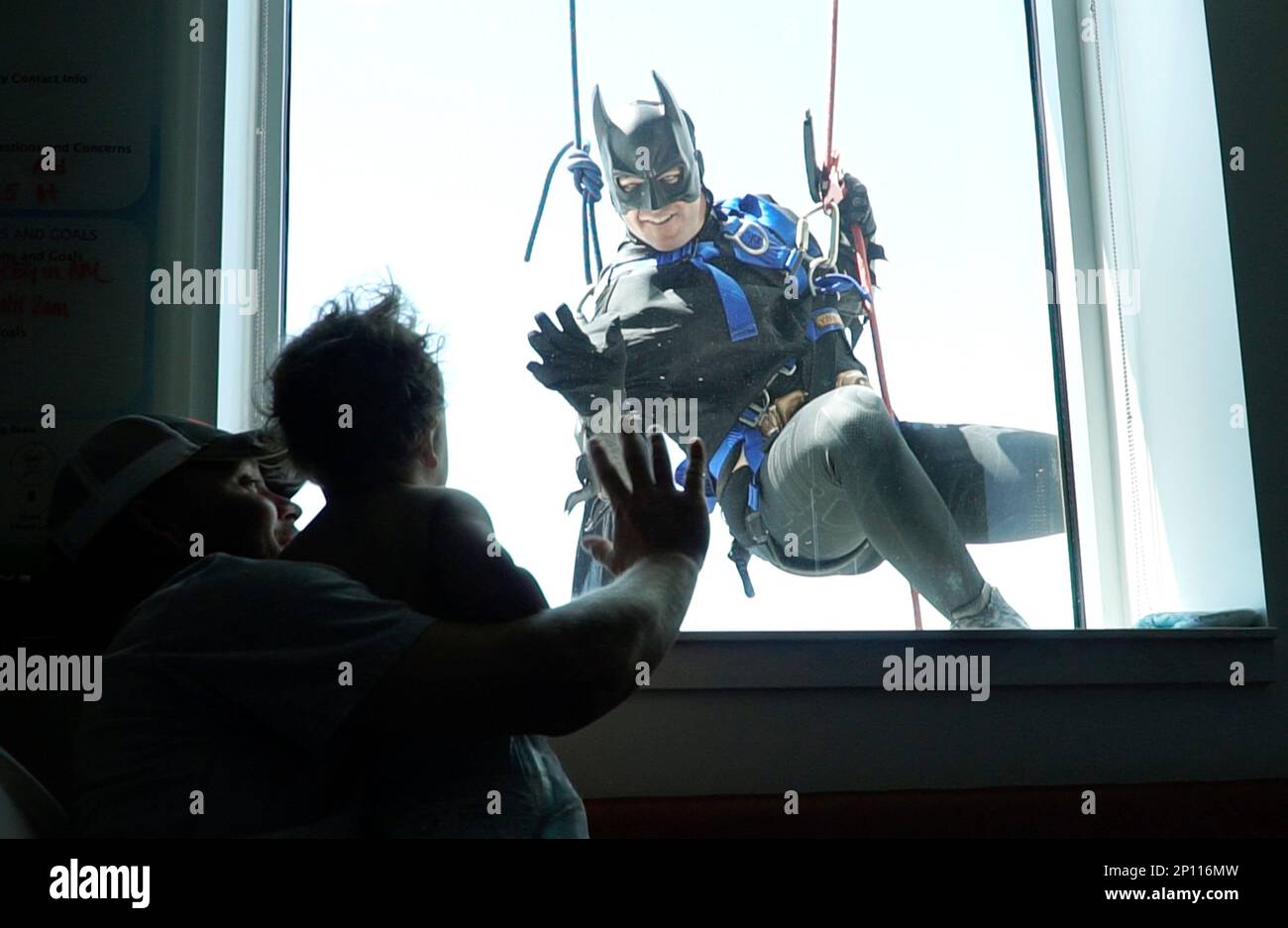 Clay Shelton and his 20-month-old son, Tito, wave to a Wichita Police ...