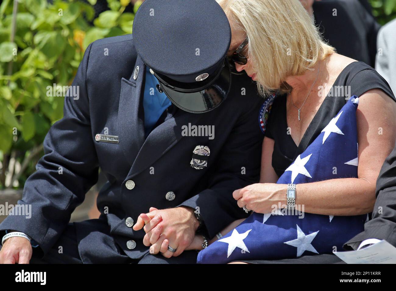 Connie Sheehan, leans on her son, Ryan Sheehan during the funeral for ...