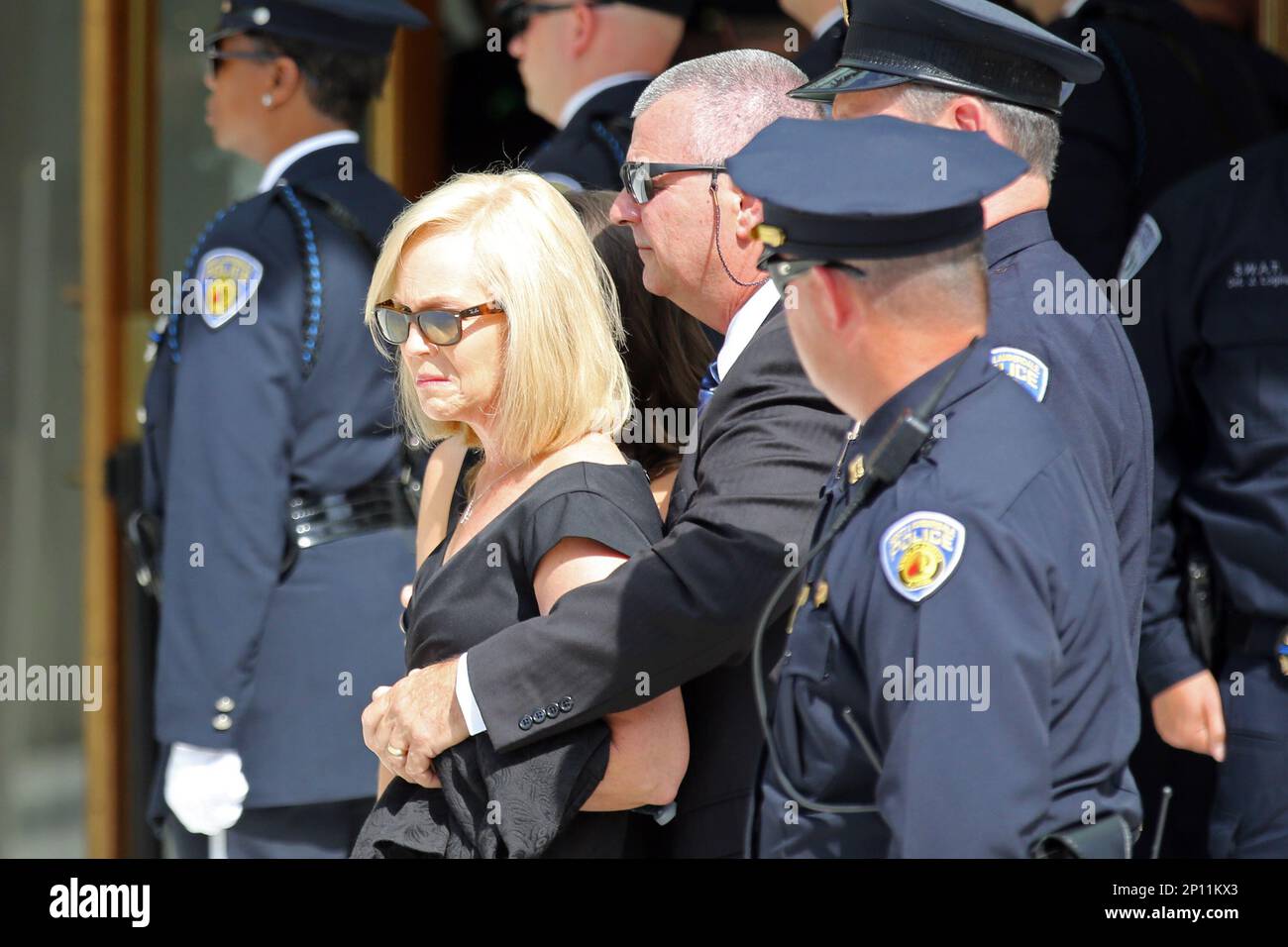 Connie and James Sheehan watches pallbearers unload the casket bearing ...