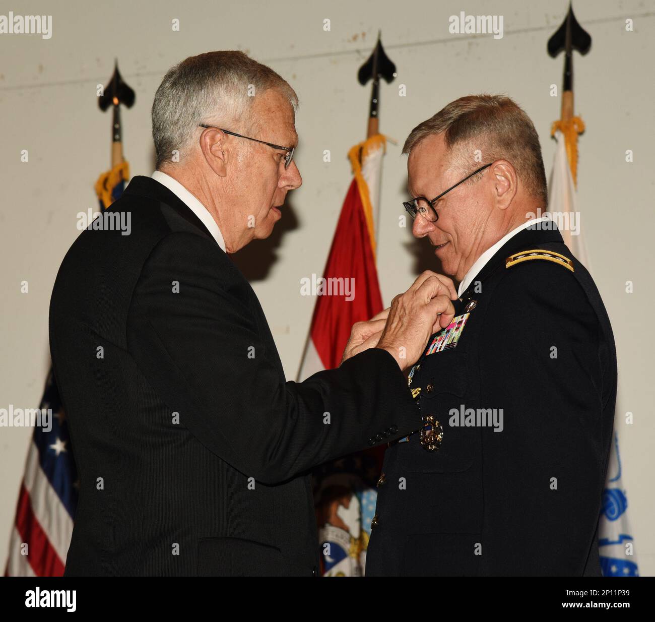 Retired Maj. Gen. Raymond "Fred" Rees, left, places a retirement pin on ...