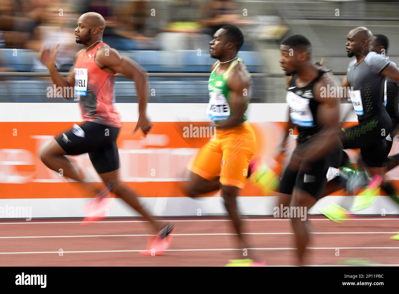 Asafa Powell, left, from Jamaica, competes in the men's 100m race at ...