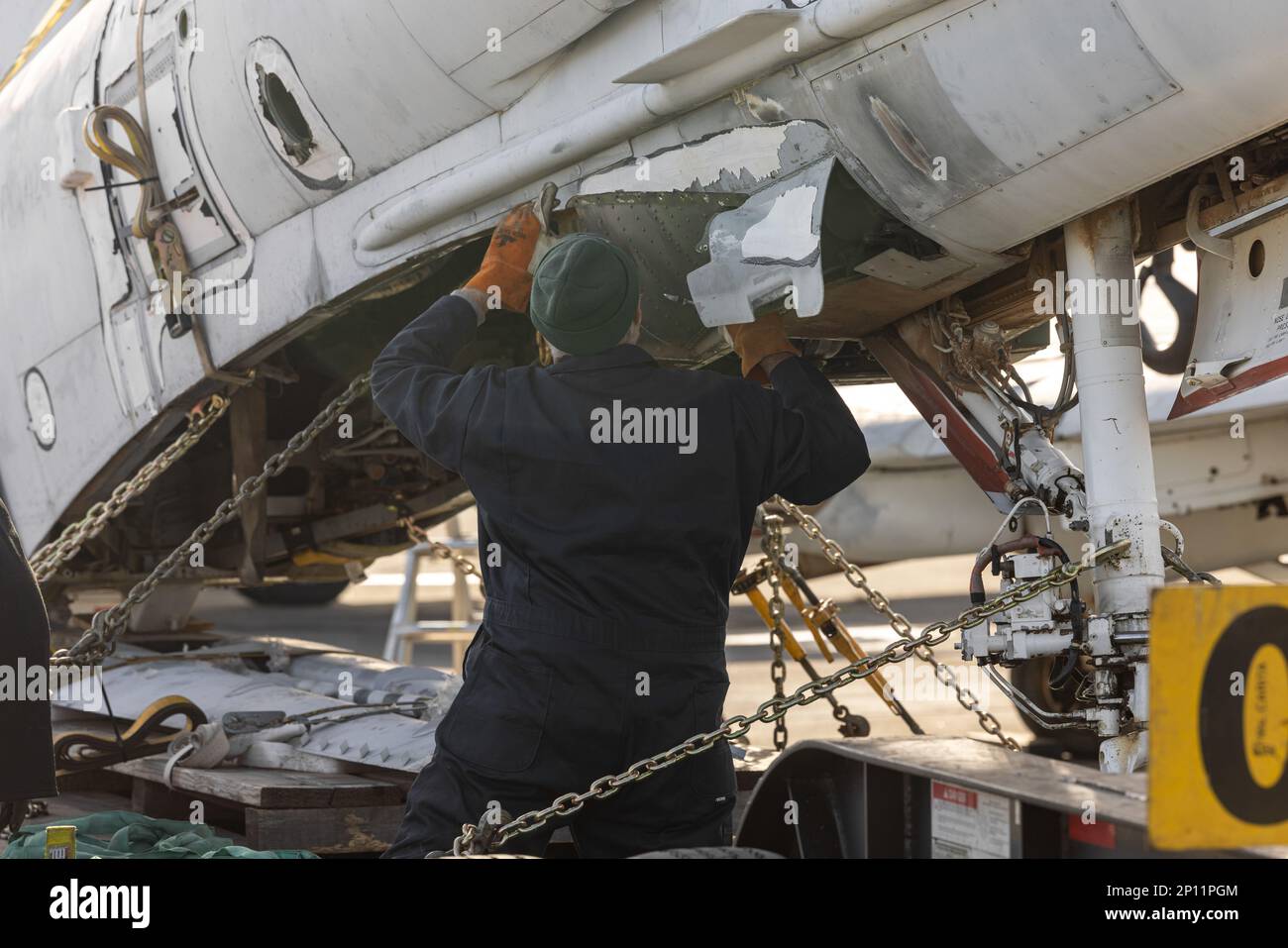 Fleet Readiness Center East (FRCE) contractors unload the body of an A ...