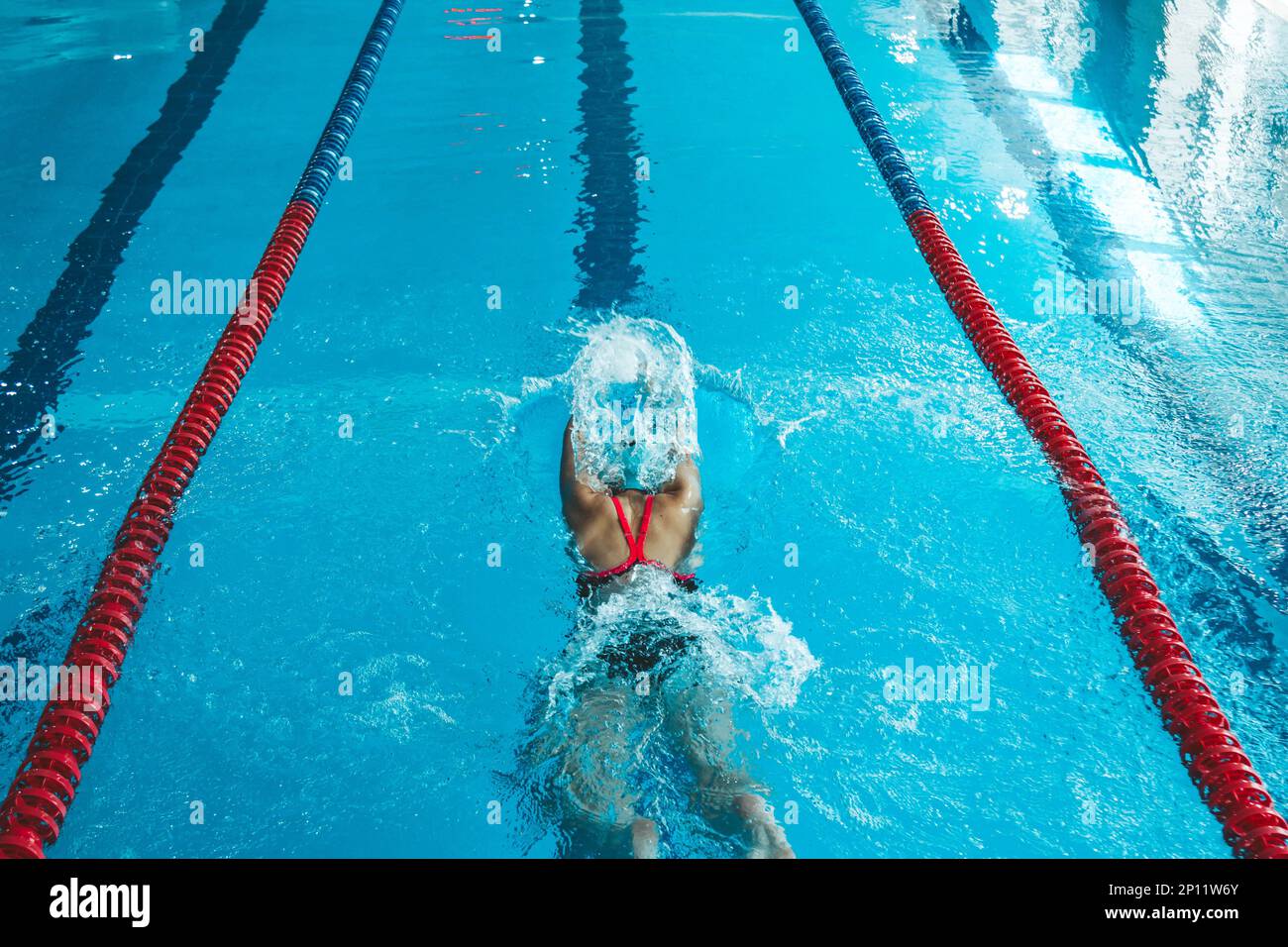 Successful female swimmer swimming in the pool. A professional athlete ...