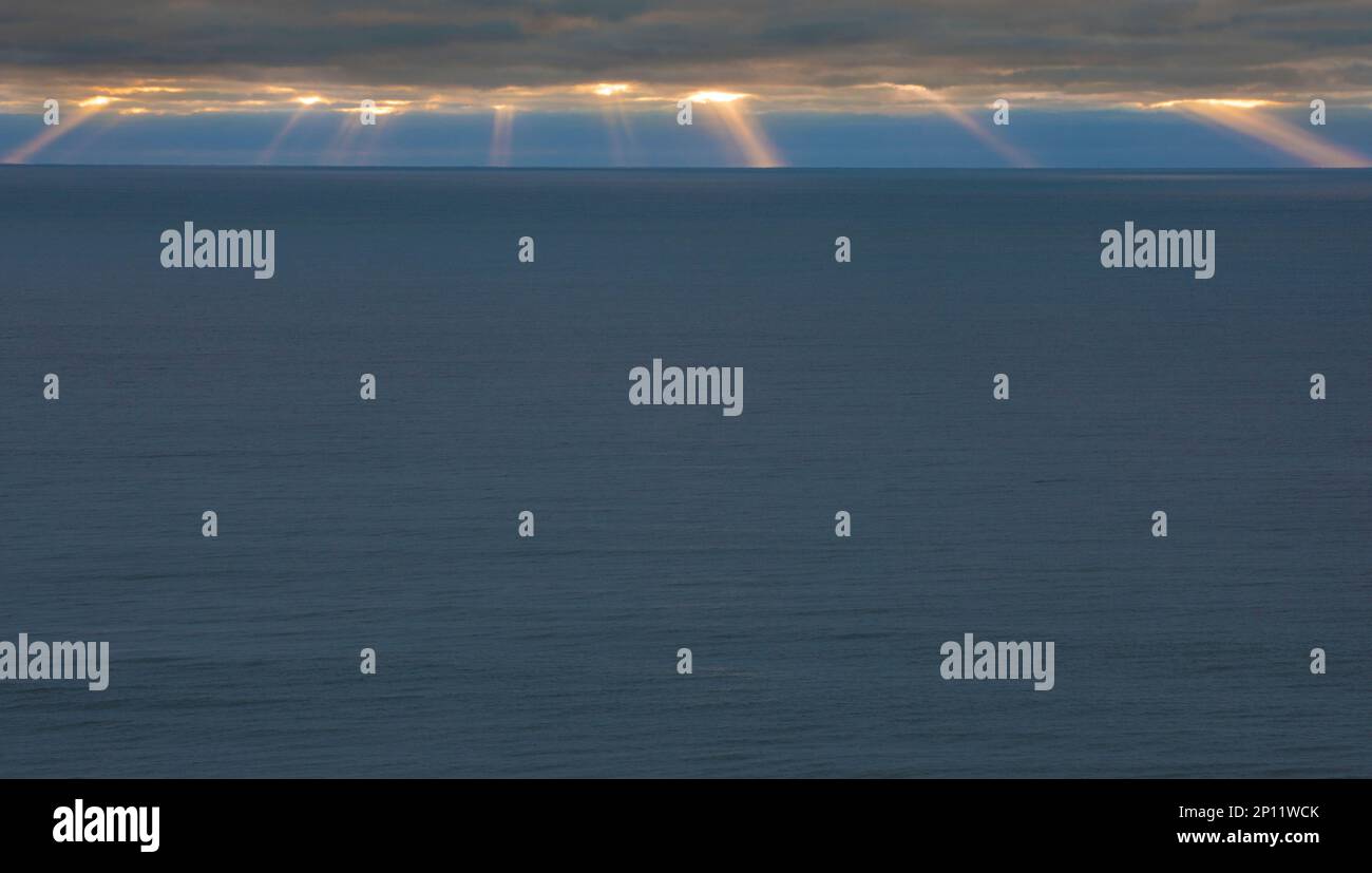 Sun peeking through the clouds over the Atlantic Ocean Stock Photo - Alamy