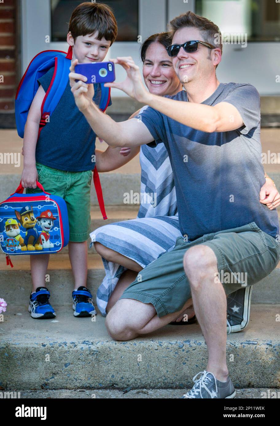 Ben Mathias, 5, poses for a selfie with his parents Mitch and Liz ...