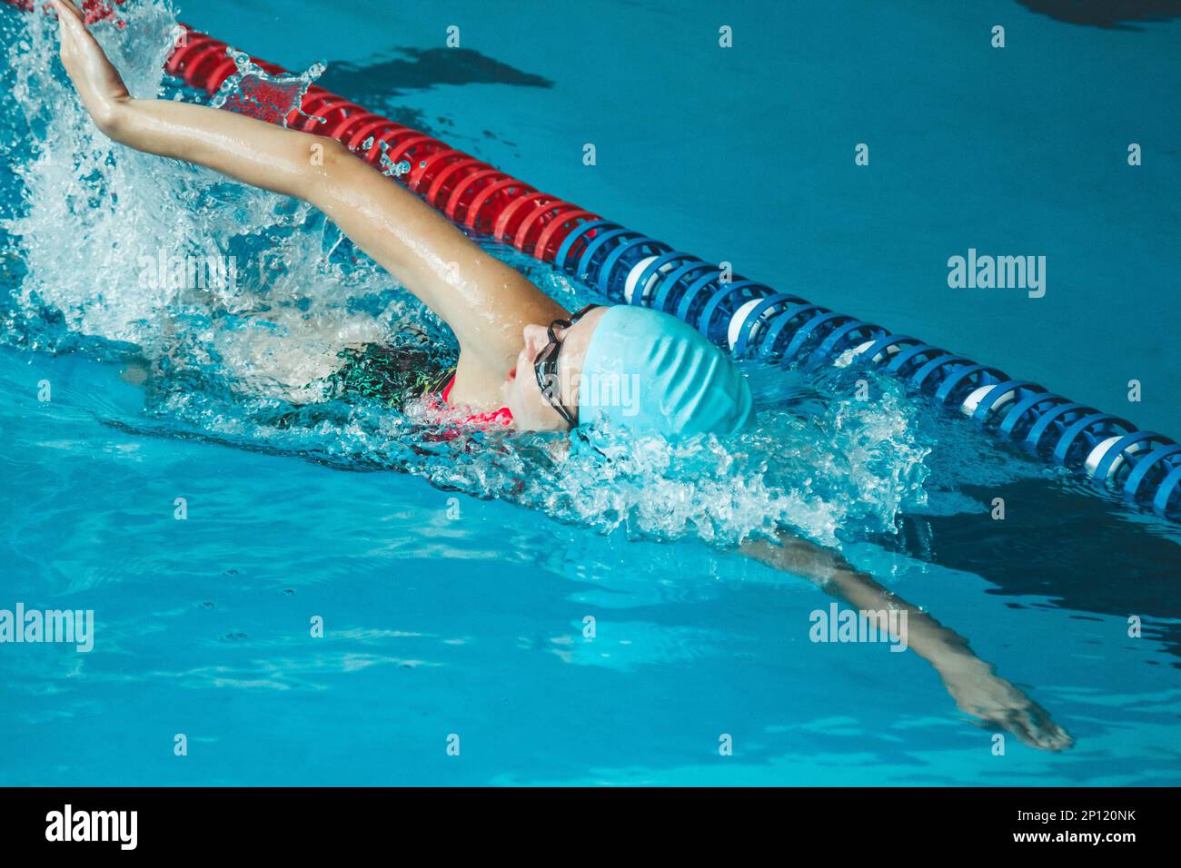 A young swimmer performs a forward crawl technique. The theme of sports ...
