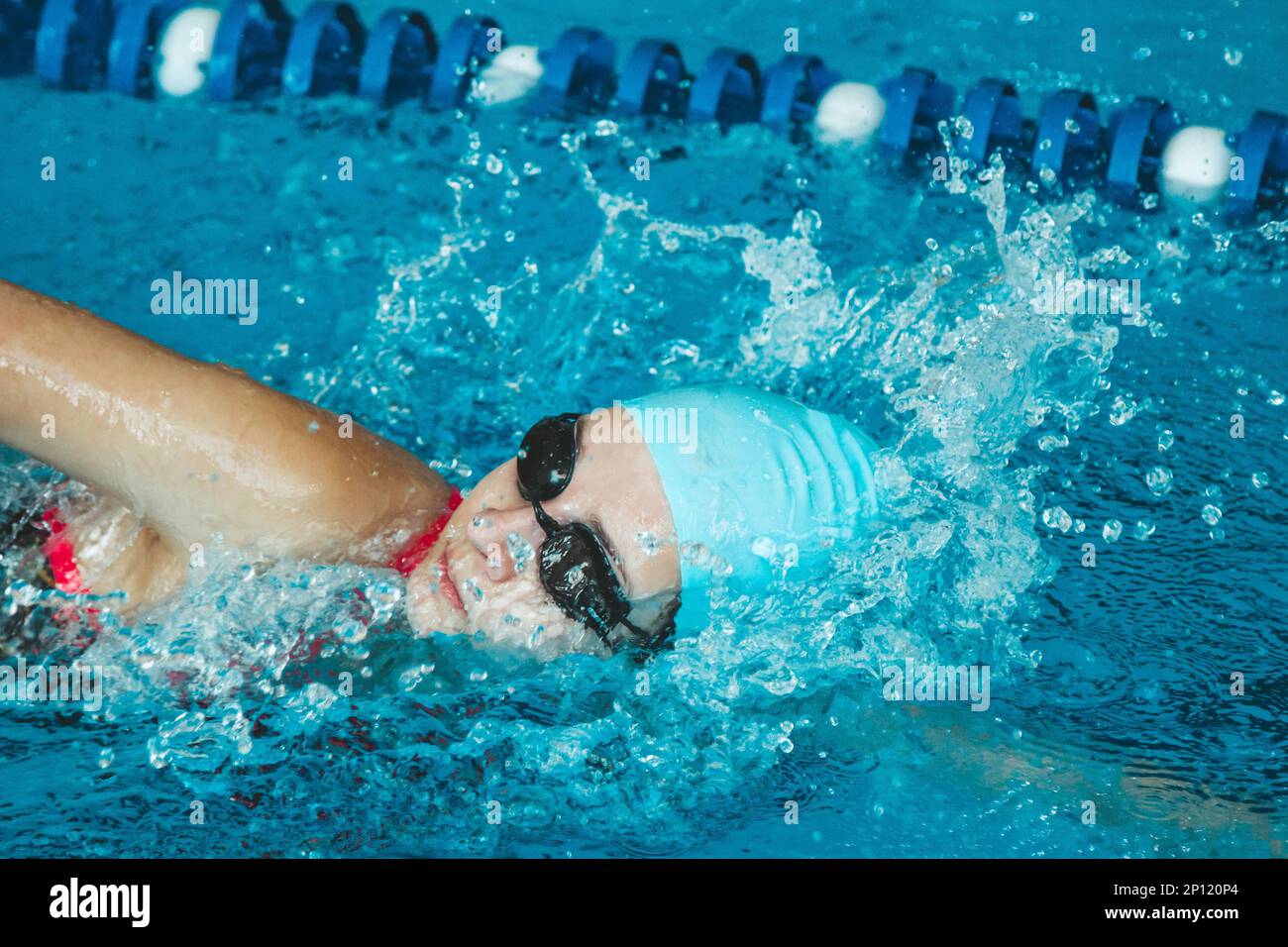A young swimmer performs a forward crawl technique. The theme of sports ...