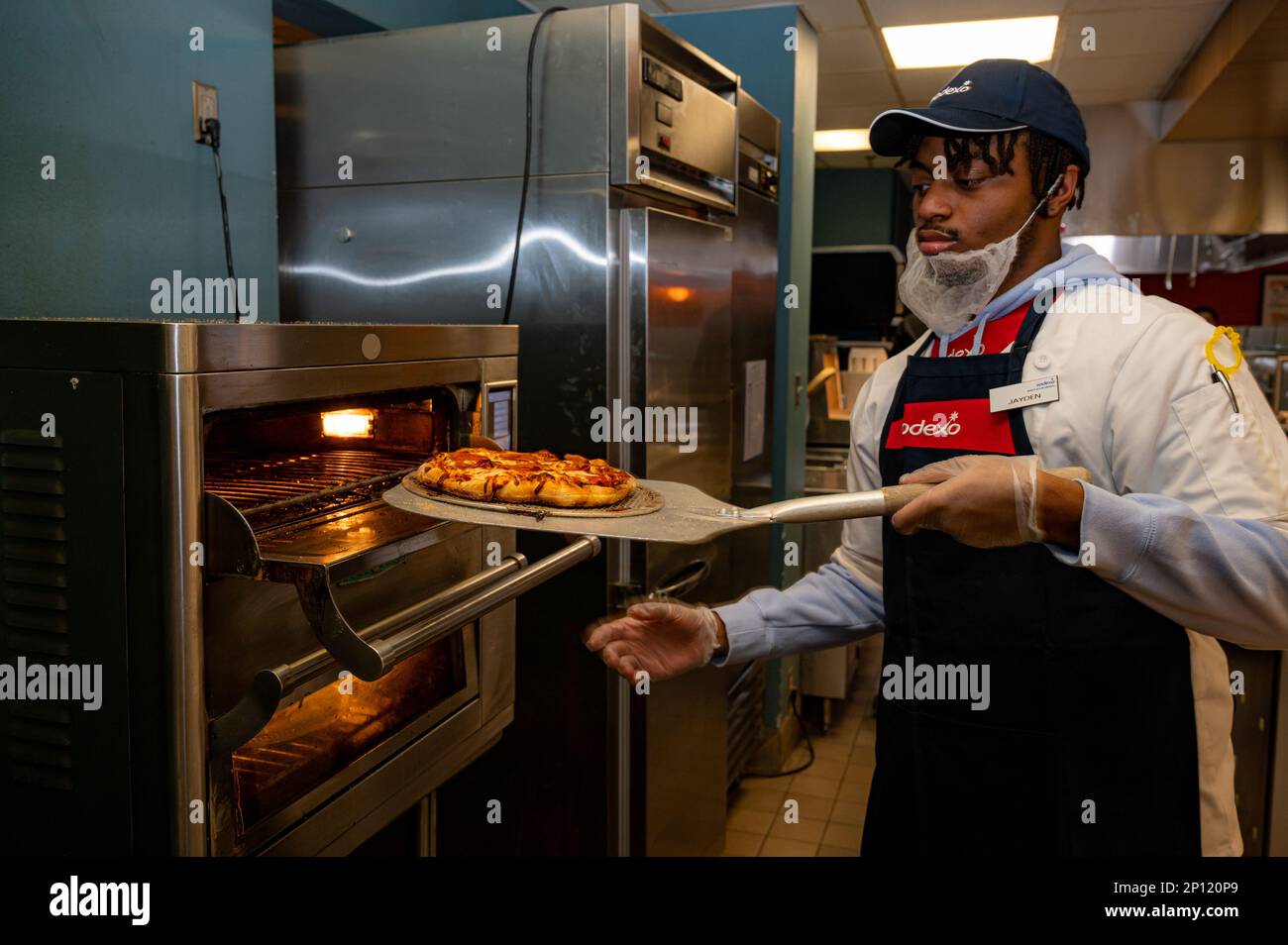 A Dakota Inn dining facility (DFAC) contract employee bakes a pizza ...