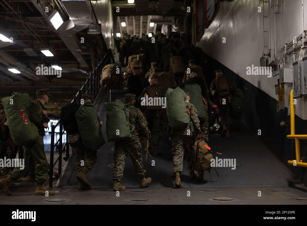 U.S. Marines board Amphibious Assault Ship USS Bataan (LHD 5) during ...