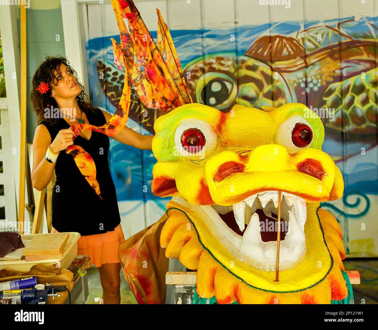 Beth Warmath works on a dragon head that will be part of a 30-foot ...