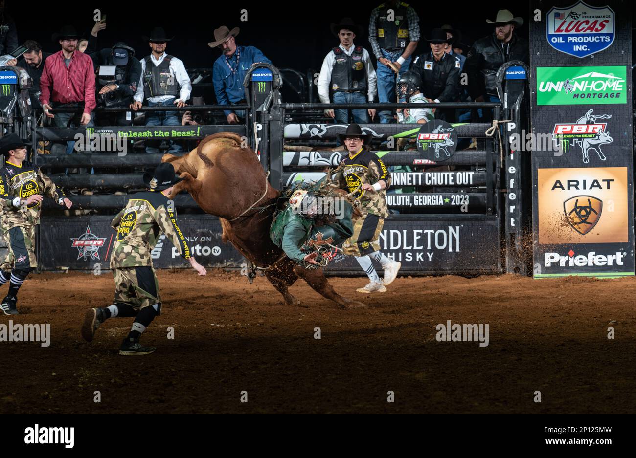 A professional bull rider competes at the PBR event “Unleash The Beast ...