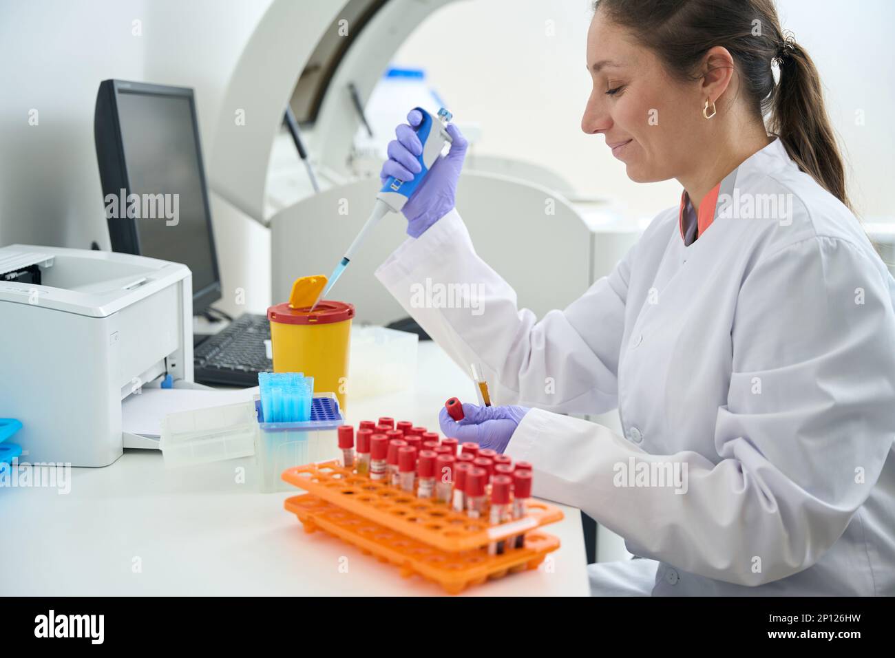Laboratory employee holds test tube with blood samples Stock Photo - Alamy