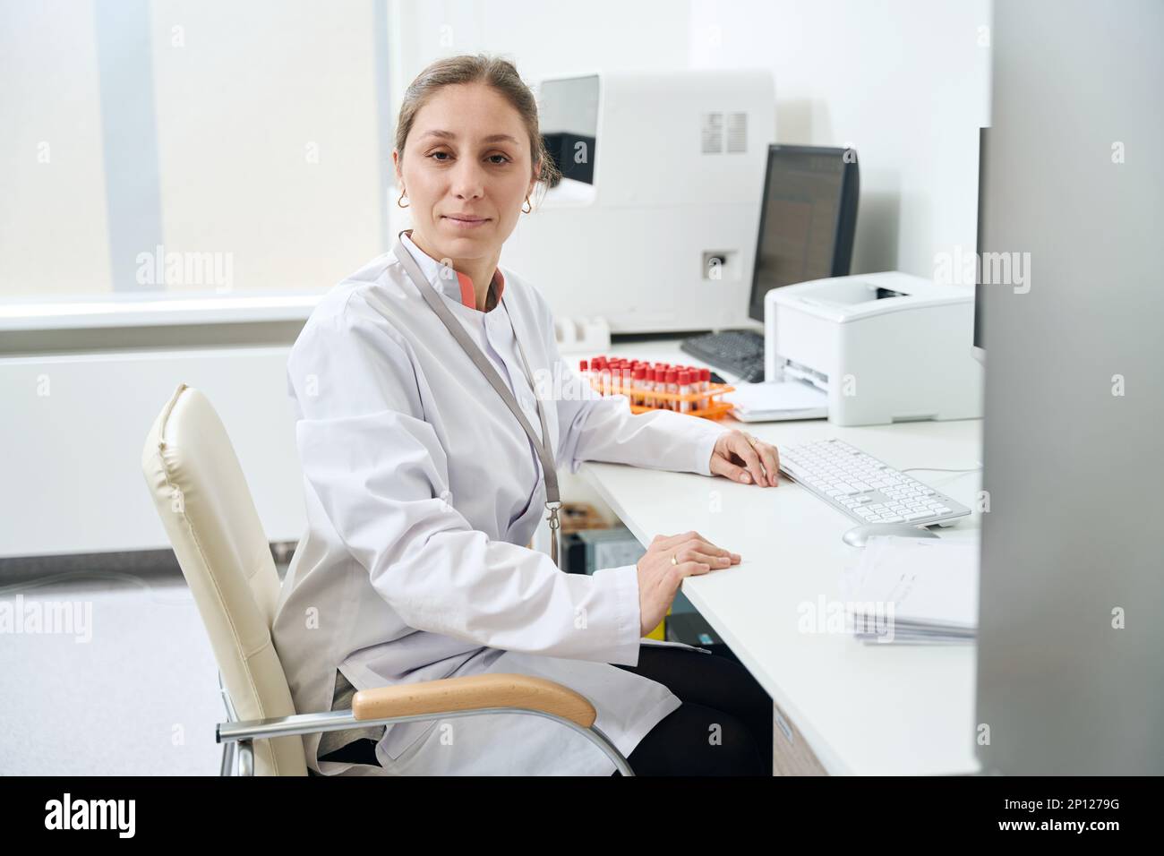 Laboratory employee is sitting at her desk Stock Photo - Alamy