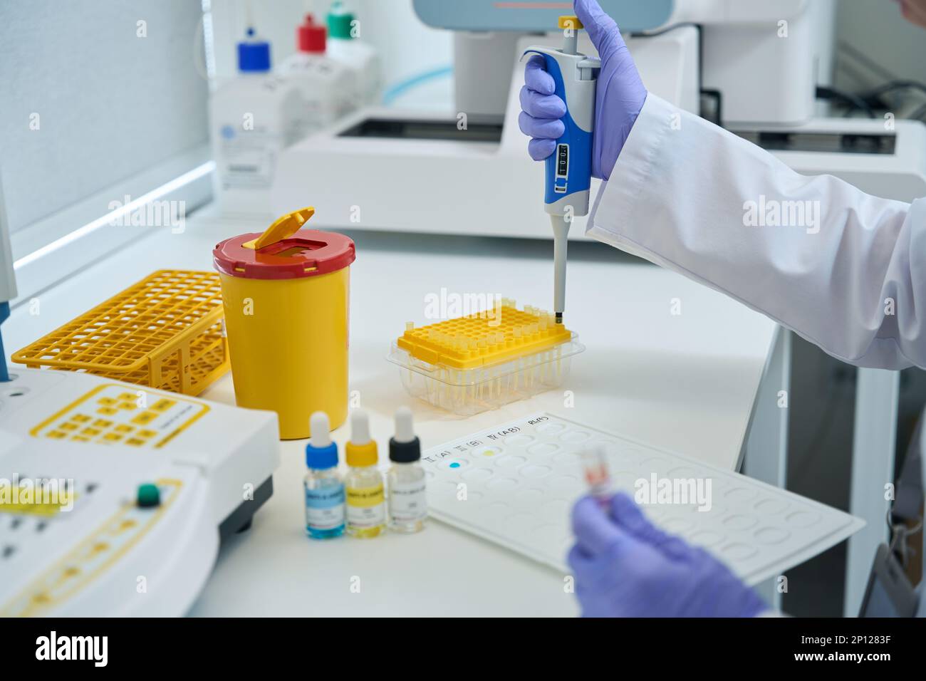 Laboratory doctor collects biomaterial with a special dispenser Stock ...