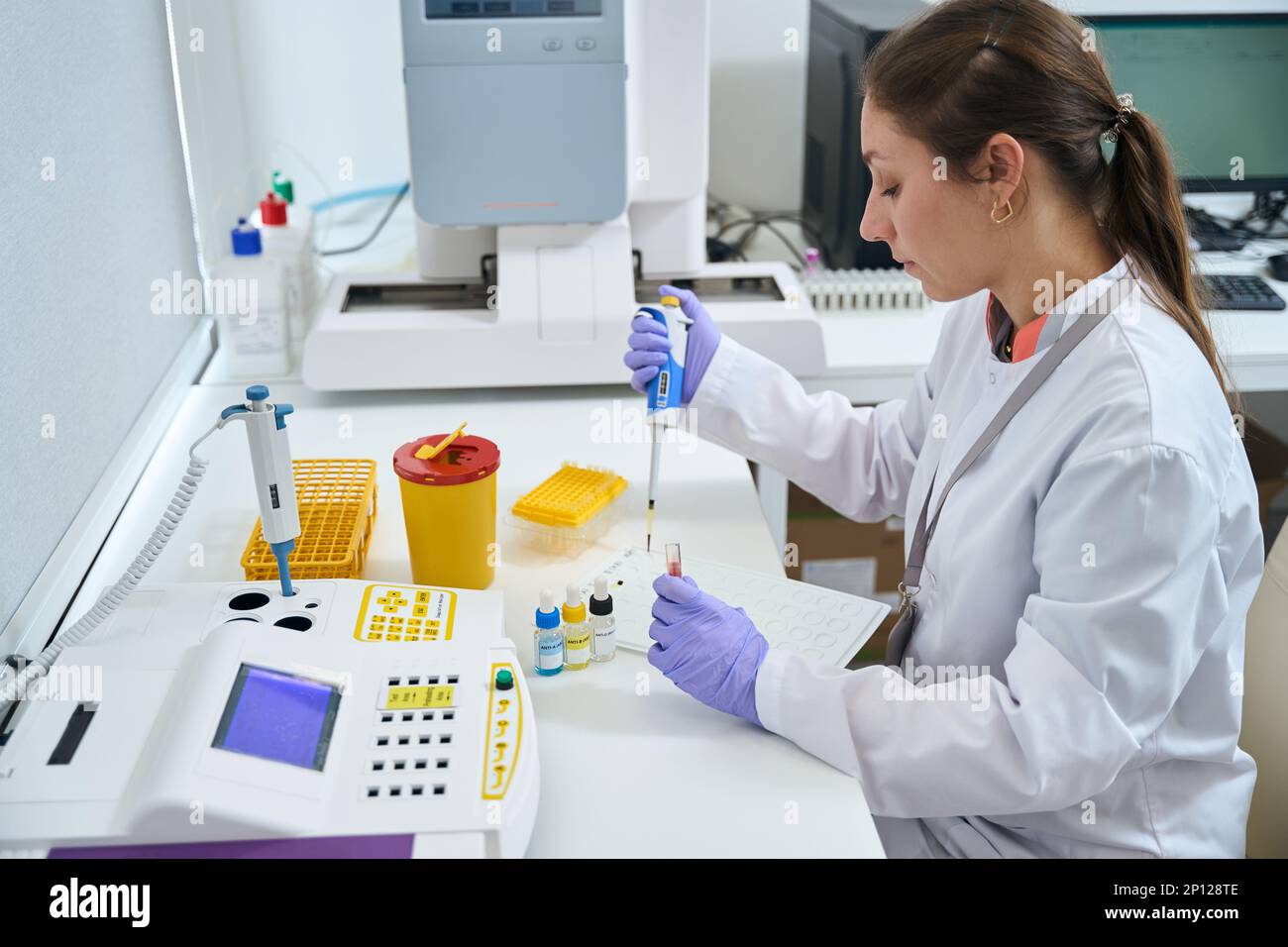 Female laboratory assistant uses special pipette to work with ...
