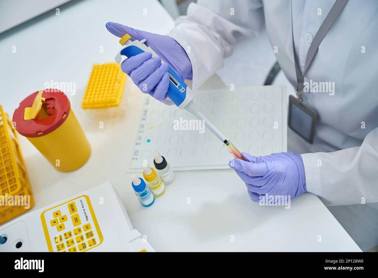 Doctor in the laboratory collects blood with a special dispenser Stock ...