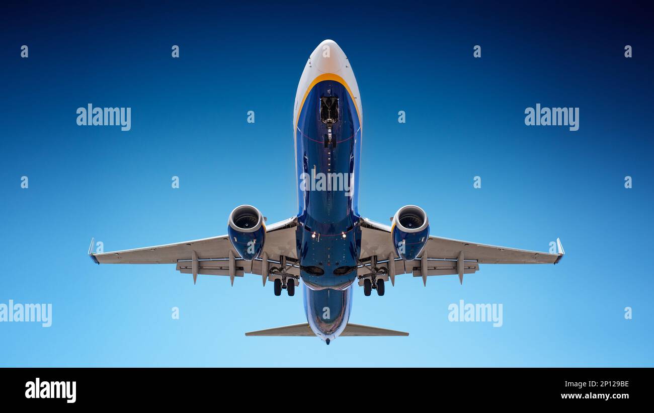 Front view of passenger airplane landing. Plane on blue sky Stock Photo ...
