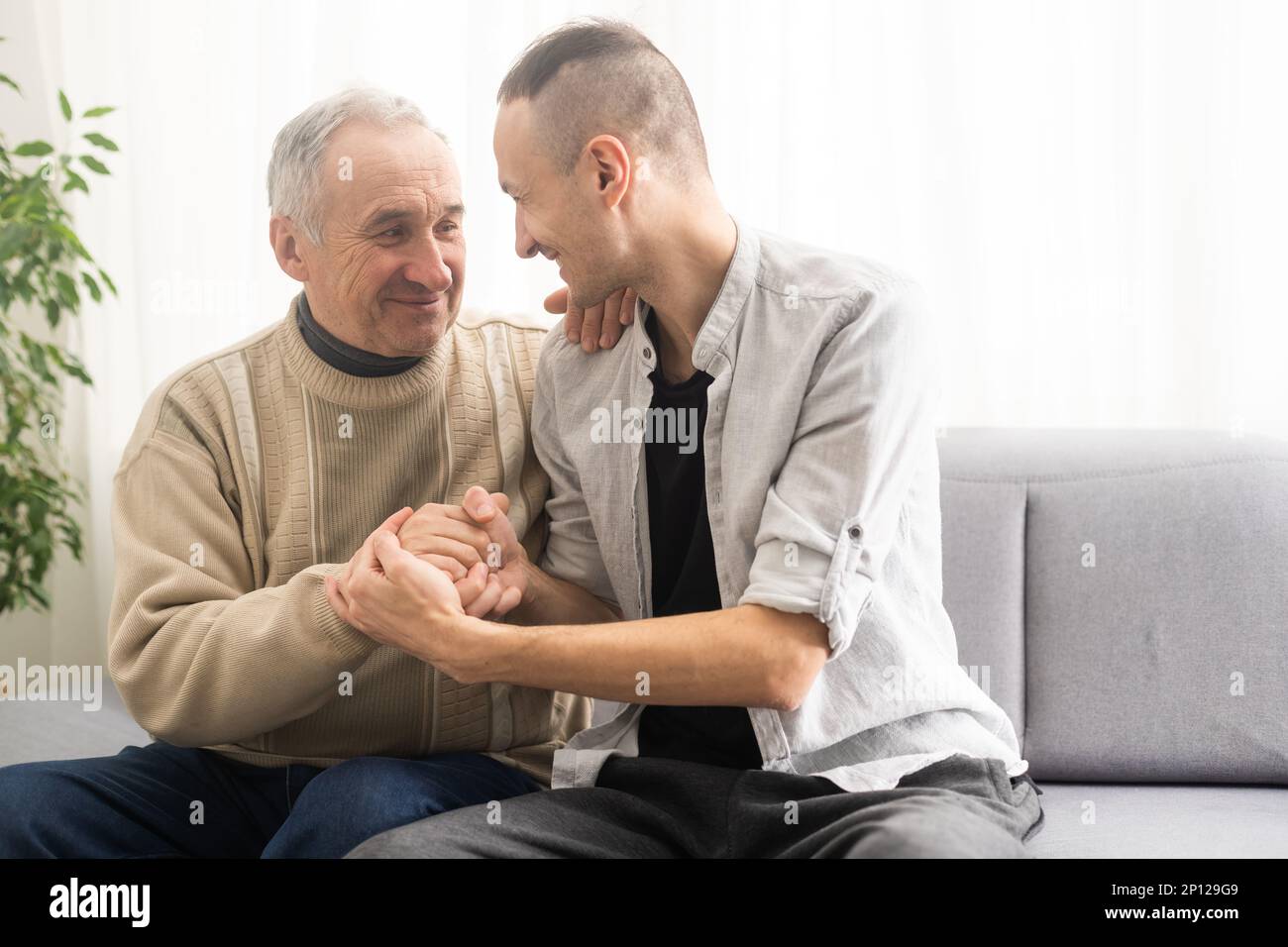 Happy two generations male family old senior mature father and smiling ...