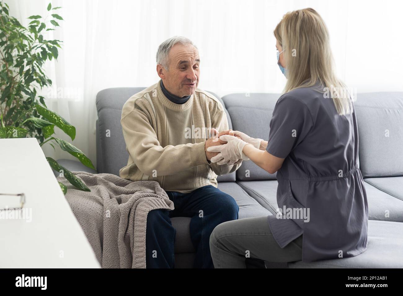 Kind female doctor embracing encouraging senior male patient in ...