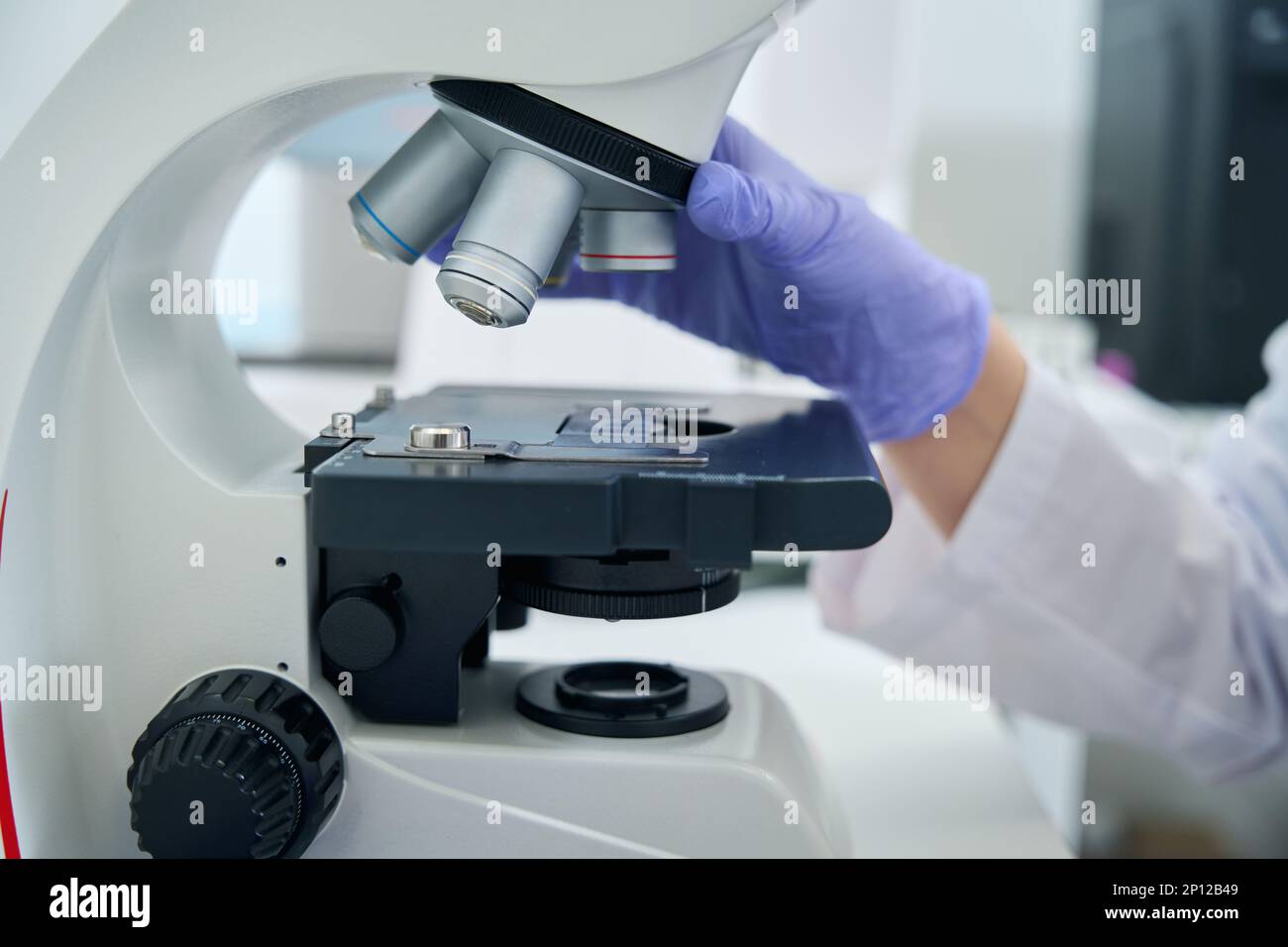 Laboratory employee works with a powerful microscope at the workplace ...