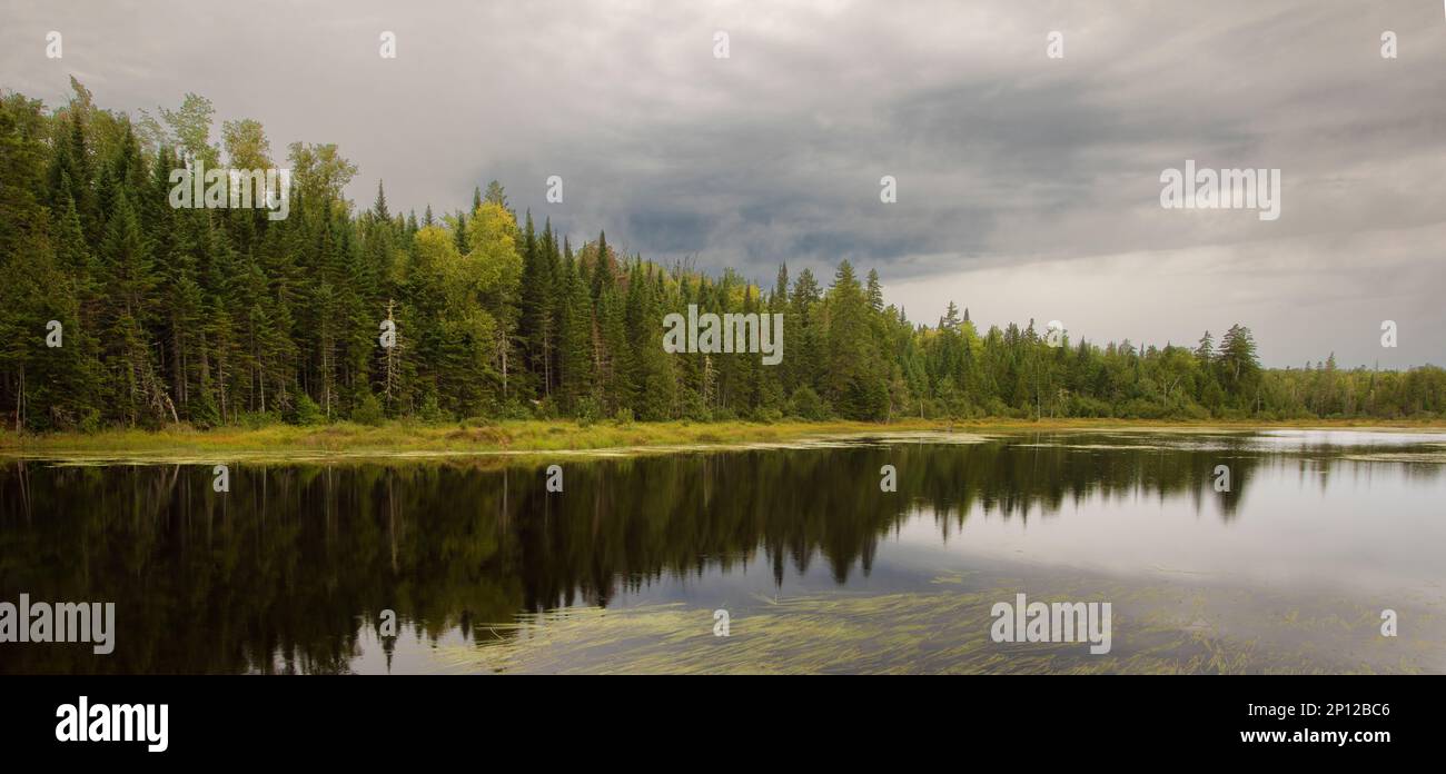 Ran storm moving in over a small pond in Maine in early September Stock ...