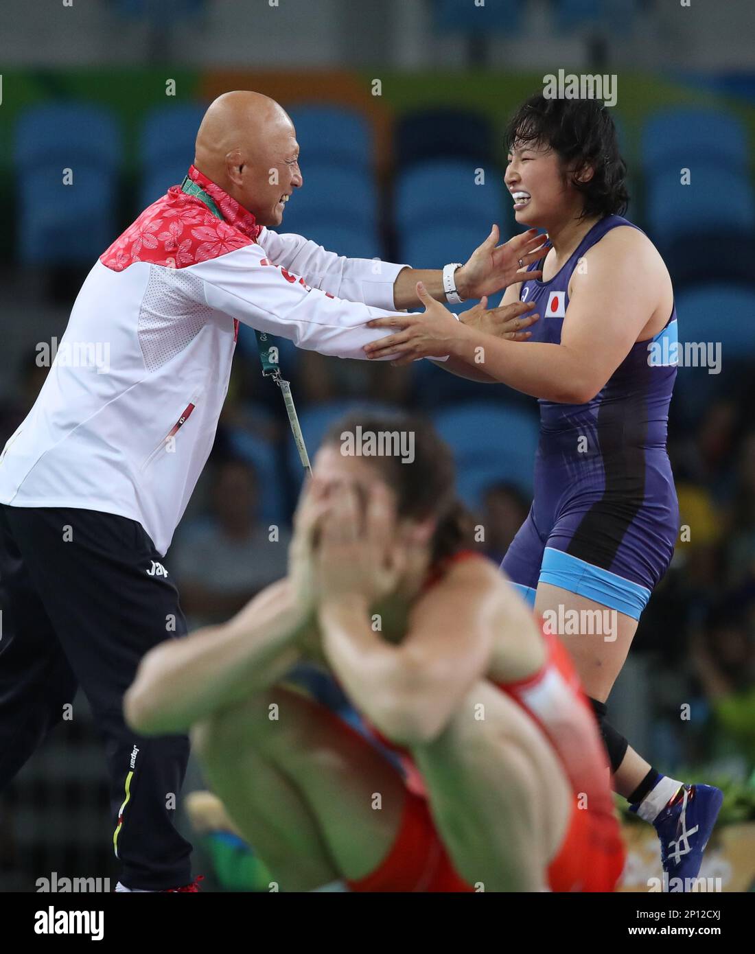 Japan's wrestler Sara Dosho (R) celebrates with a team leader Kazuto ...