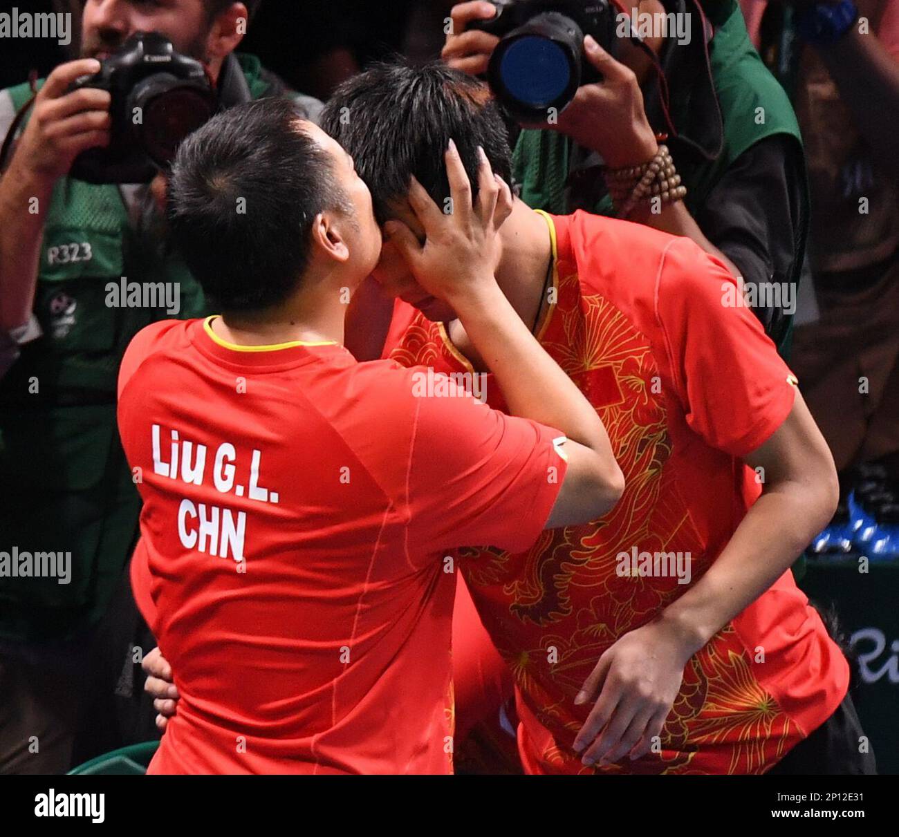 Coach of China's national table tennis team Liu Guoliang, left, kisses ...