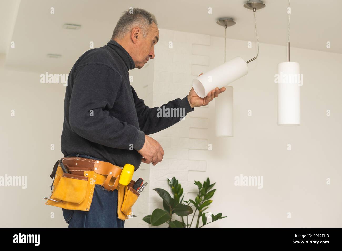 Elderly man changing light bulbs : Retired man doing household chores ...
