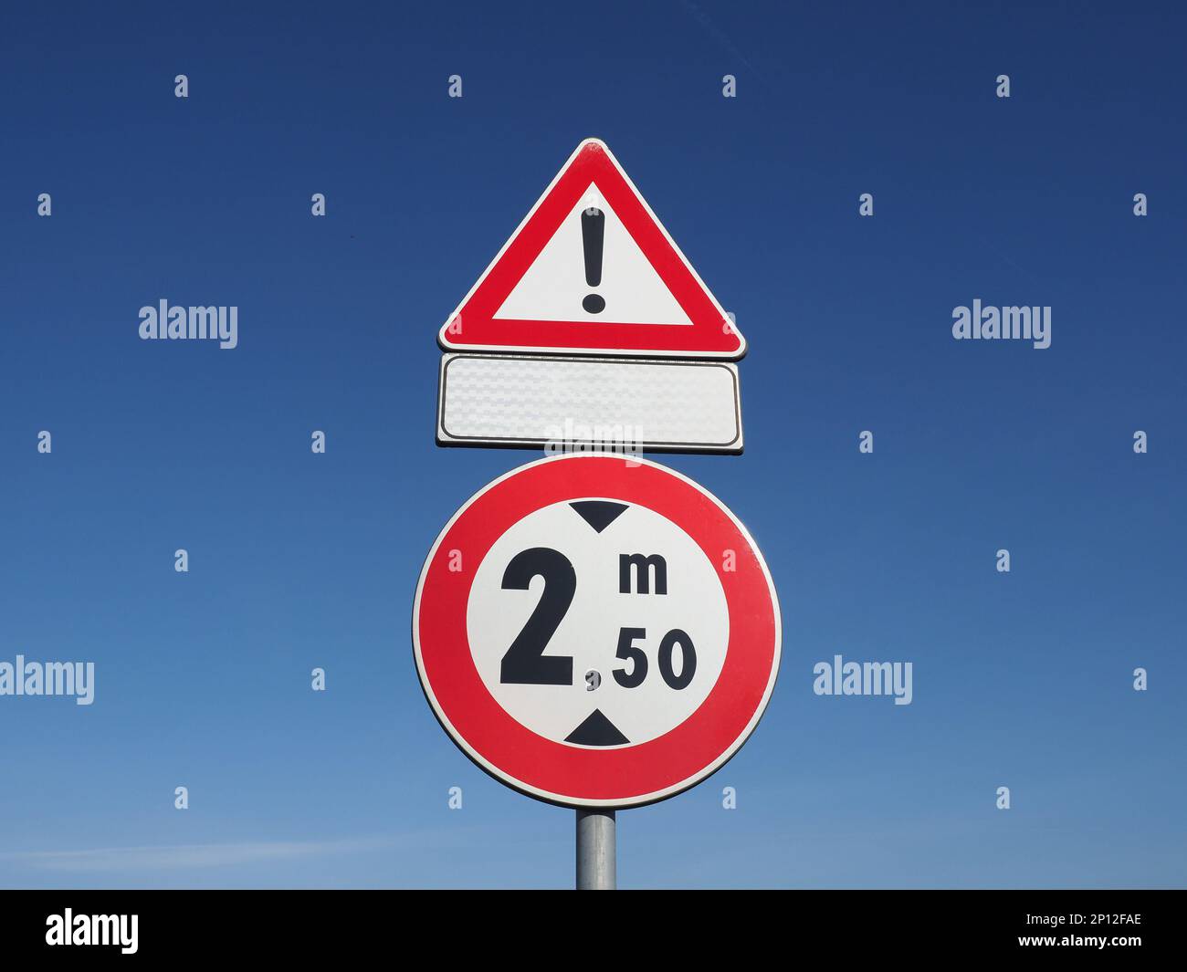danger and height limit traffic sign over blue sky Stock Photo - Alamy
