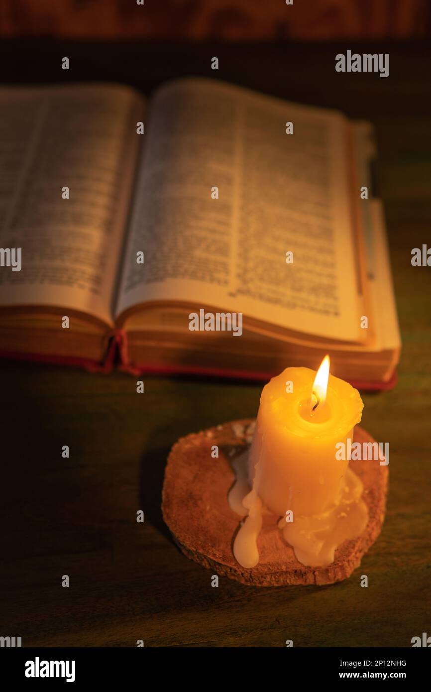 Open bible and candle hi-res stock photography and images - Alamy