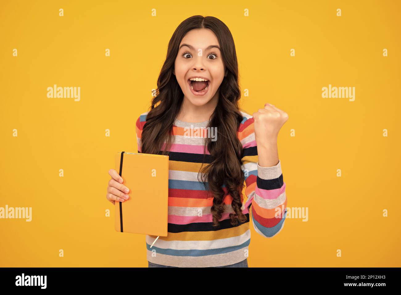 Amazed teenager. Schoolgirl with copy book posing on isolated ...