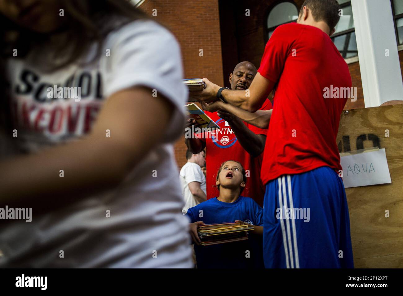 Avery Klask, 8, looks up in awe as her father Charles Klask, a Detroit ...