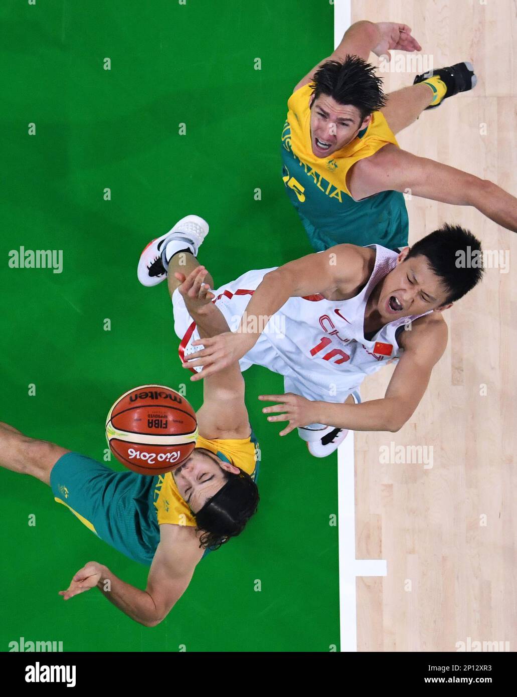 China's Zou Peng (10) shoots between Australia's Chris Goulding, bottom ...