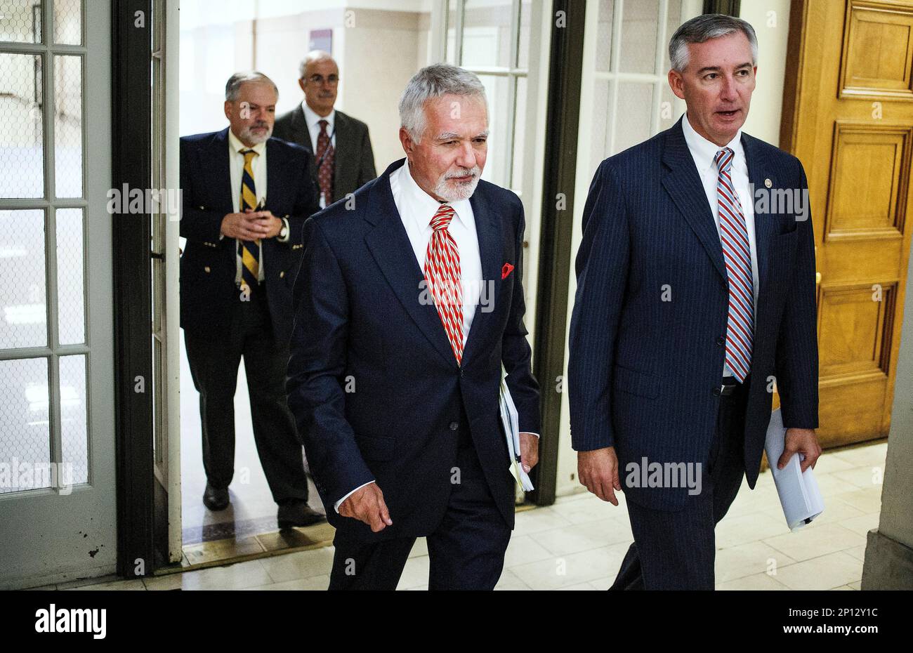 Attorney William Costopoulos, left, a witness in the trial, walks with ...