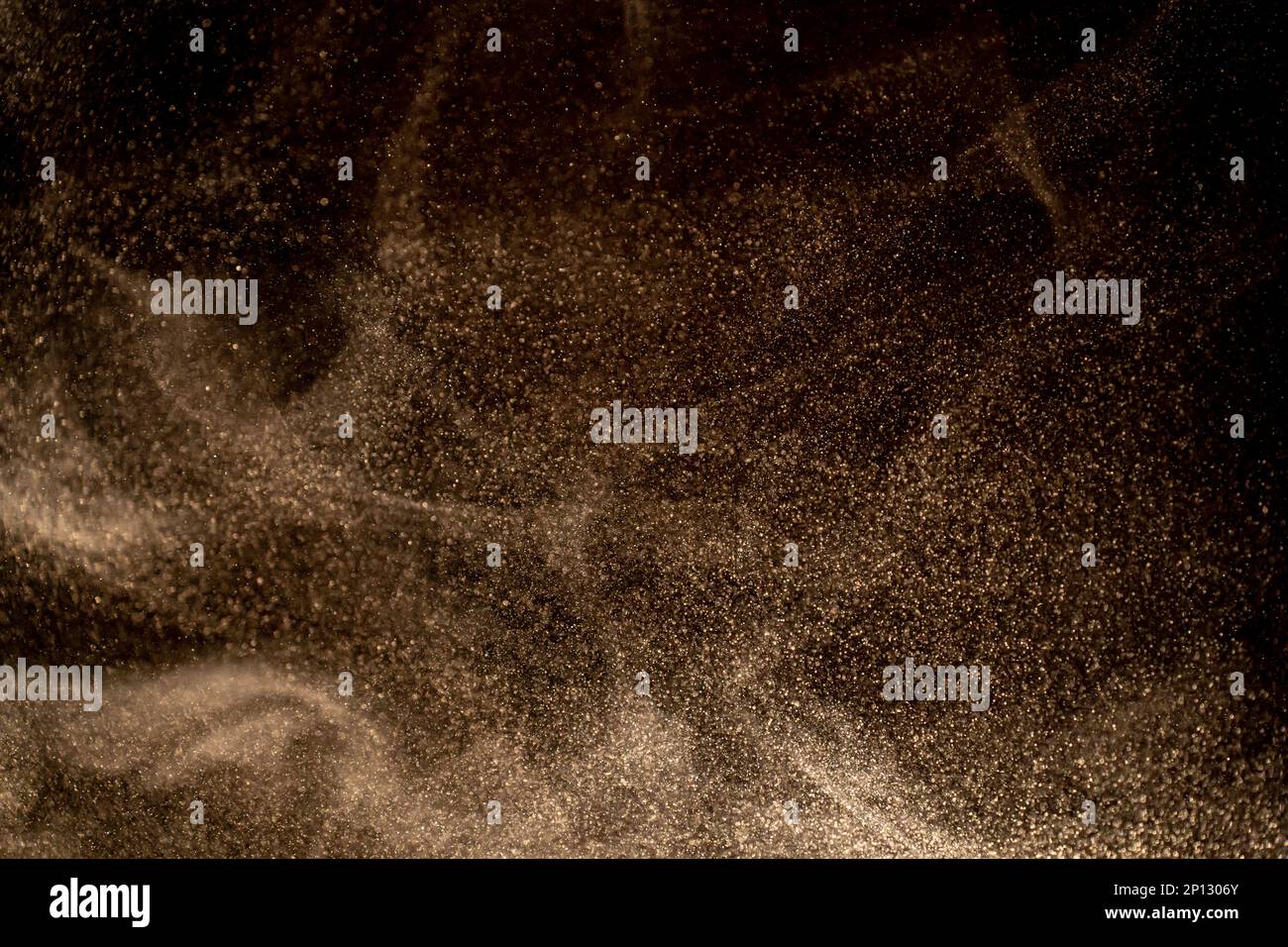 Dust particles cloud generating abstract shape on black background with ...