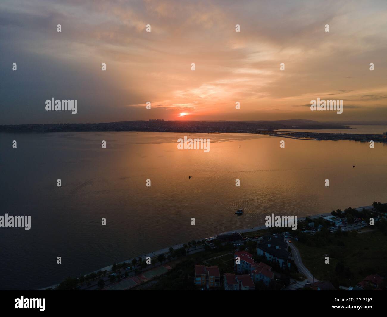 An aerial view of a beautiful bay in the evening, with the sun setting ...