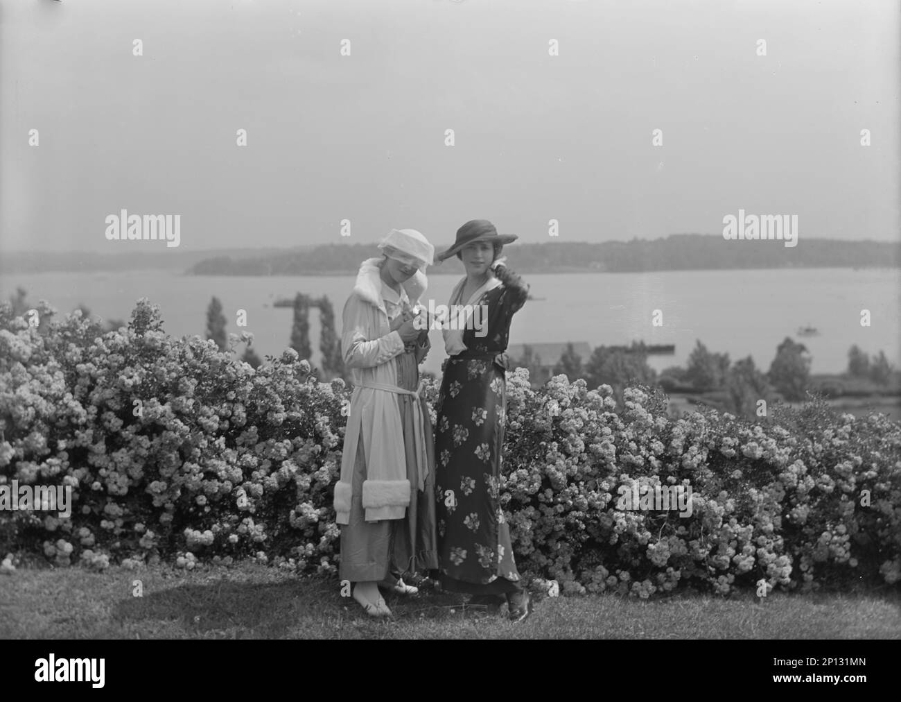 Viola Kraus and Helen Freeman standing outdoors, 1915 June Stock Photo ...