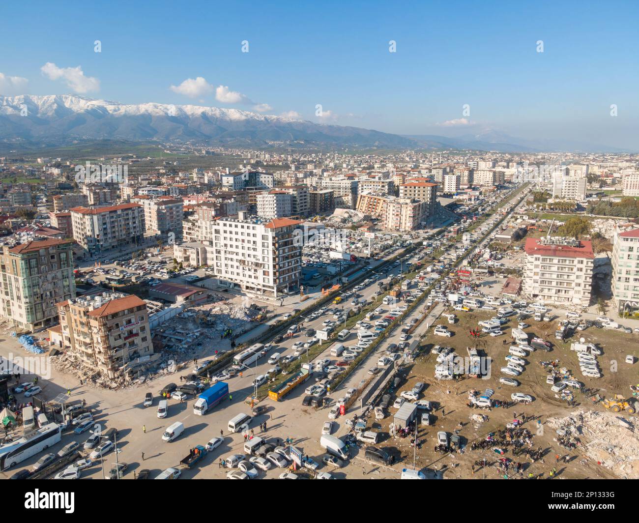 An aerial view of rescuers saving lives around the damaged buildings of ...