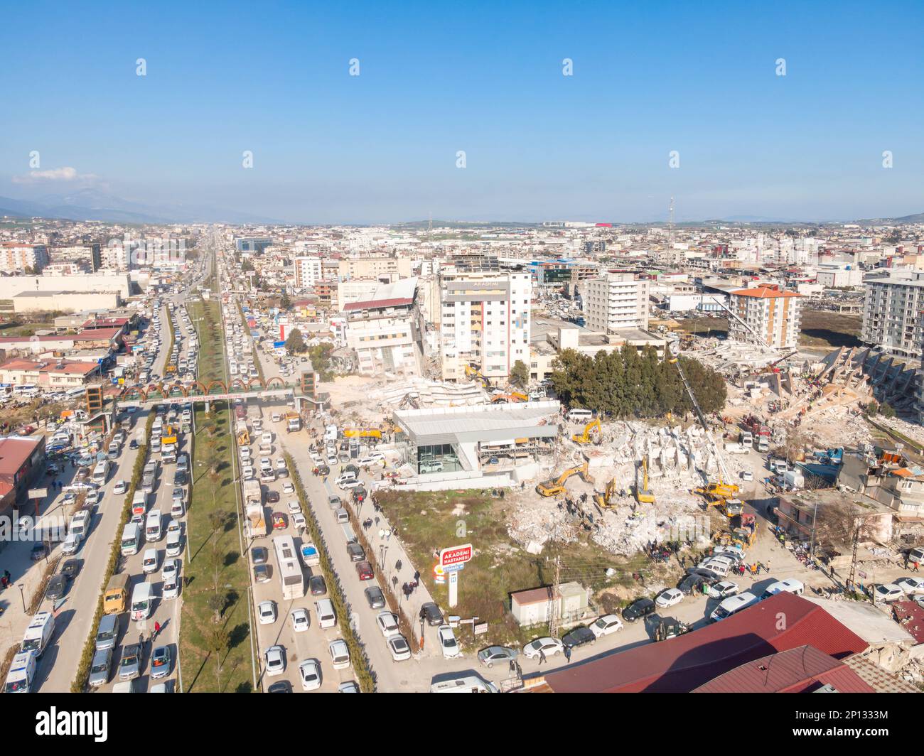 An aerial view of rescuers saving lives around the damaged buildings of ...