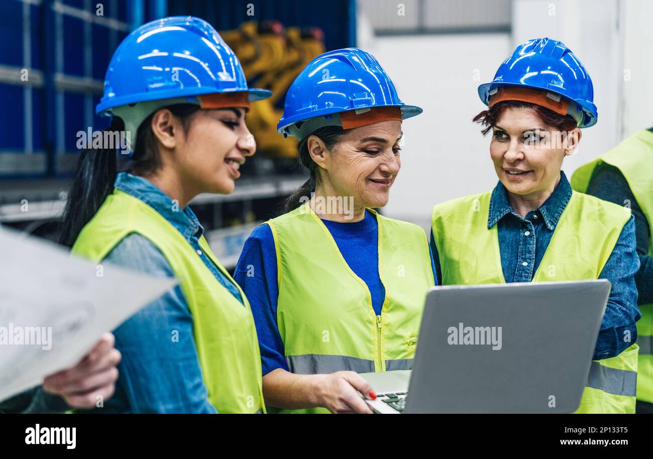 Diverse female engineers working in robotic factory - Tech industrial ...