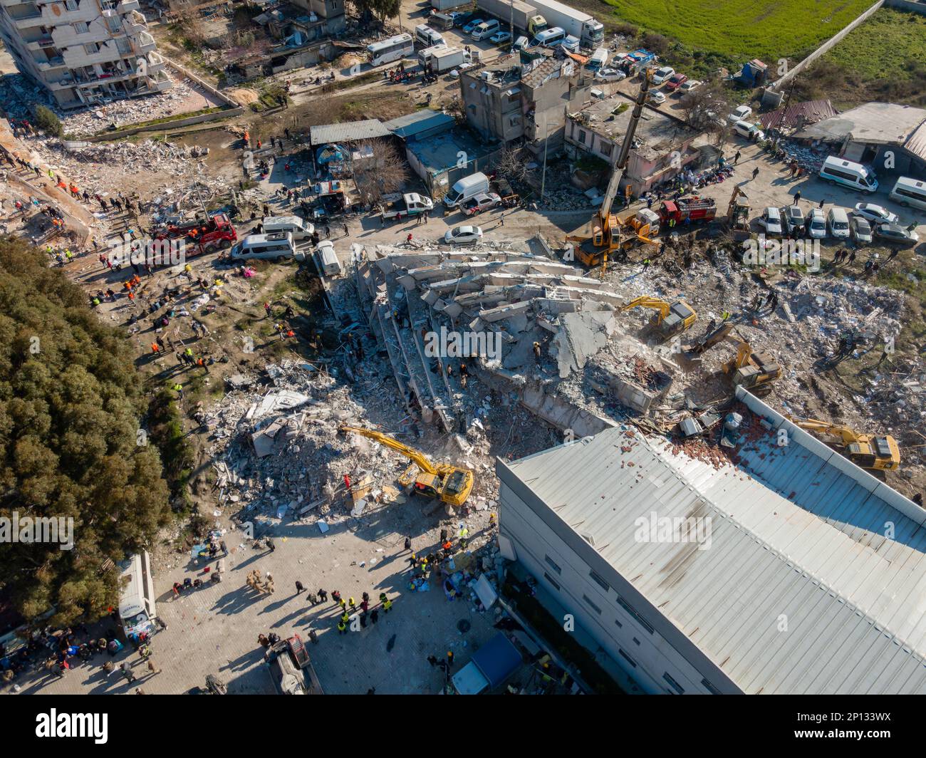 An aerial view of rescuers saving lives around the damaged buildings of ...