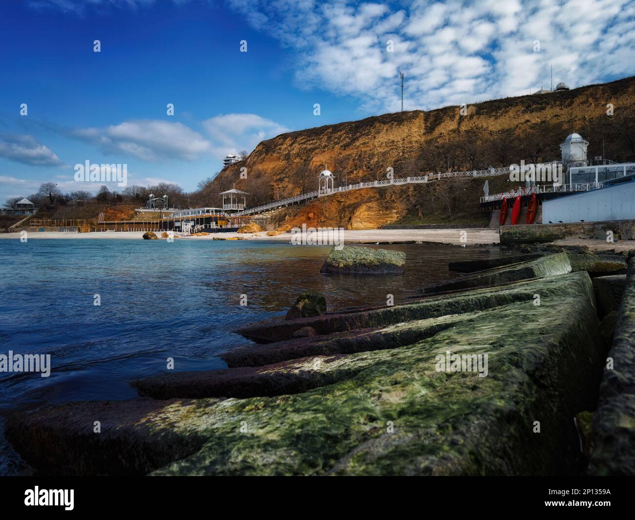 Sea coast in good weather, beach and cafe, blue sky with white clouds ...