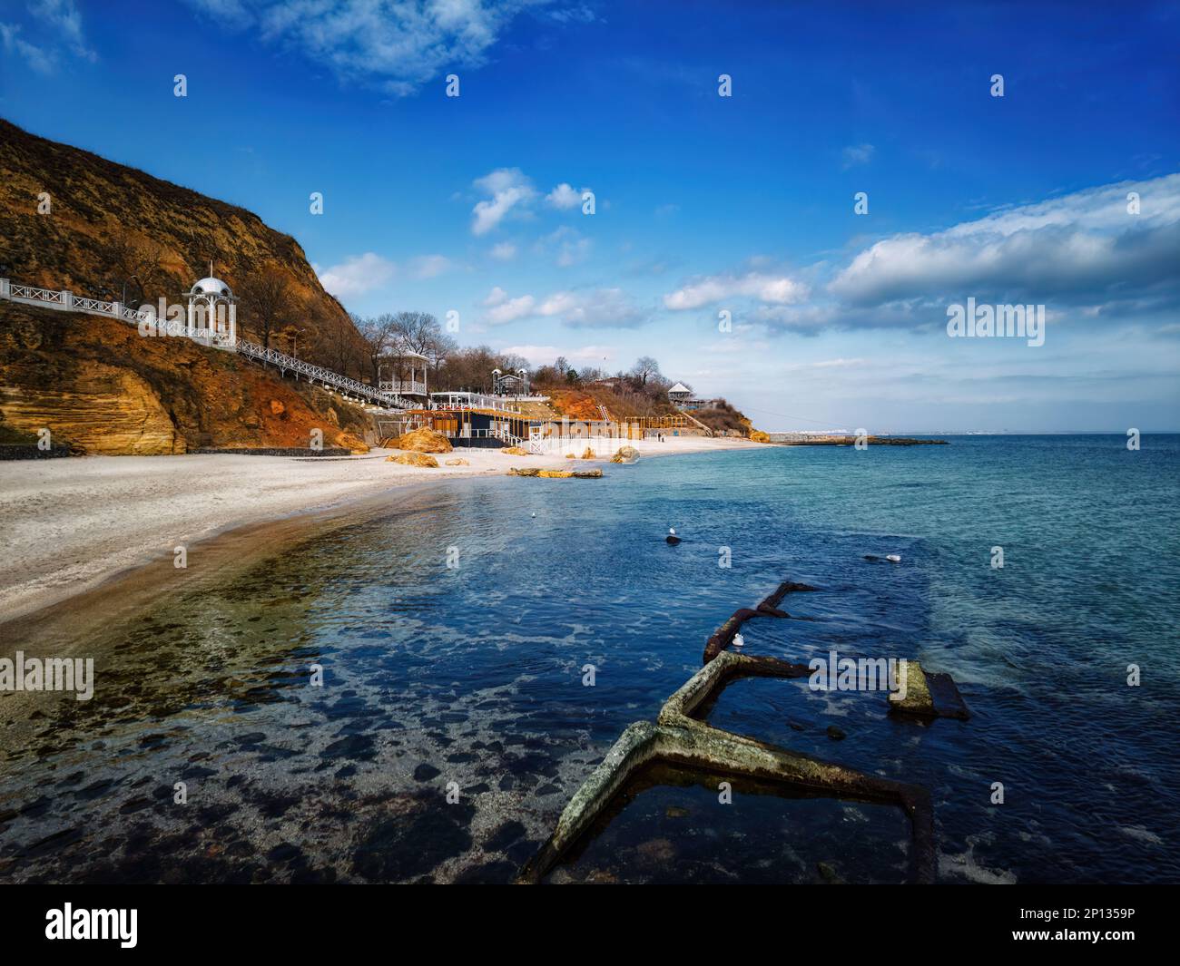 Sea coast in good weather, beach and cafe, blue sky with white clouds ...