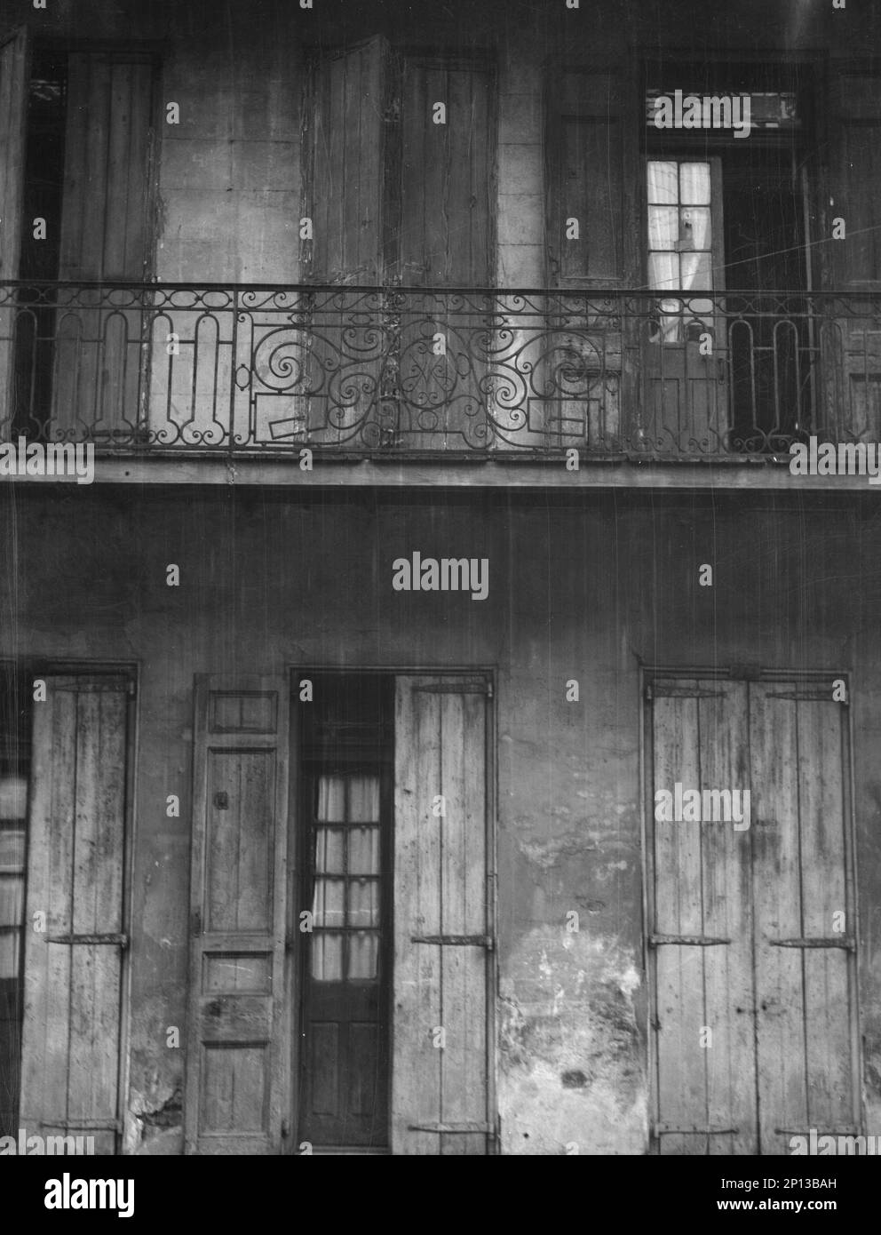 Facade of a building with shuttered doors and balcony, New Orleans or ...